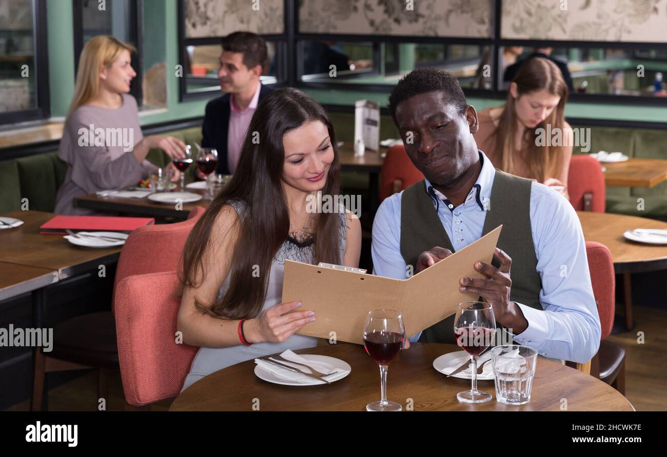 Couple choosing from menu hi-res stock photography and images - Alamy