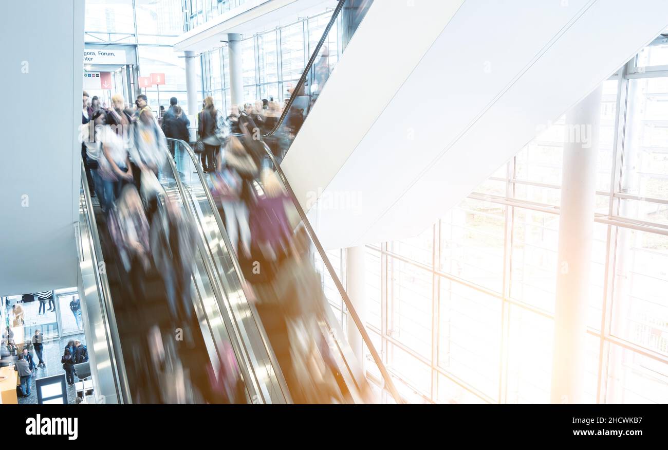 trade fair staircase with moving people Stock Photo - Alamy