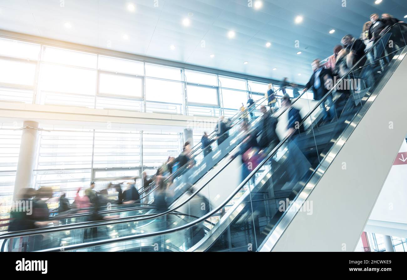 trade fair staircase with moving people Stock Photo - Alamy