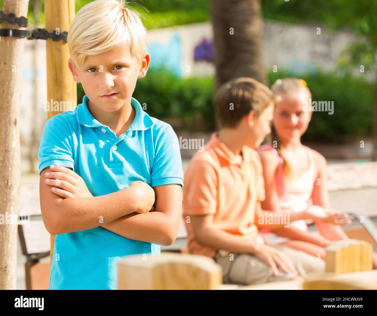 Portrait of offended boy which is standing outside of the company Stock ...