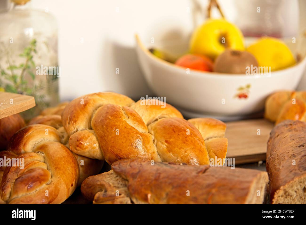 Feast, messy table. Bread in the shape of a braid. Sweet Challah ...