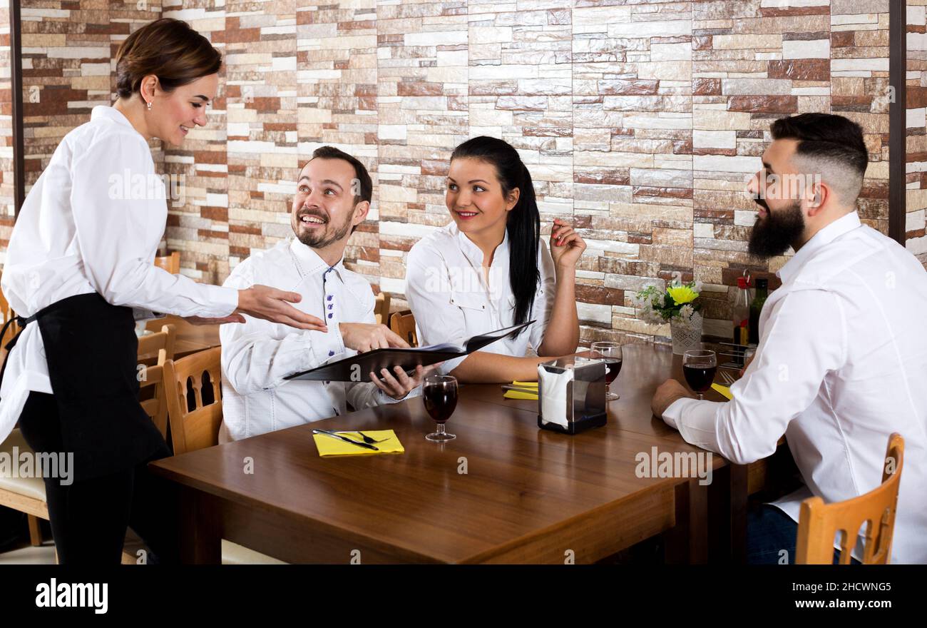 Waitress taking order at table of people Stock Photo - Alamy