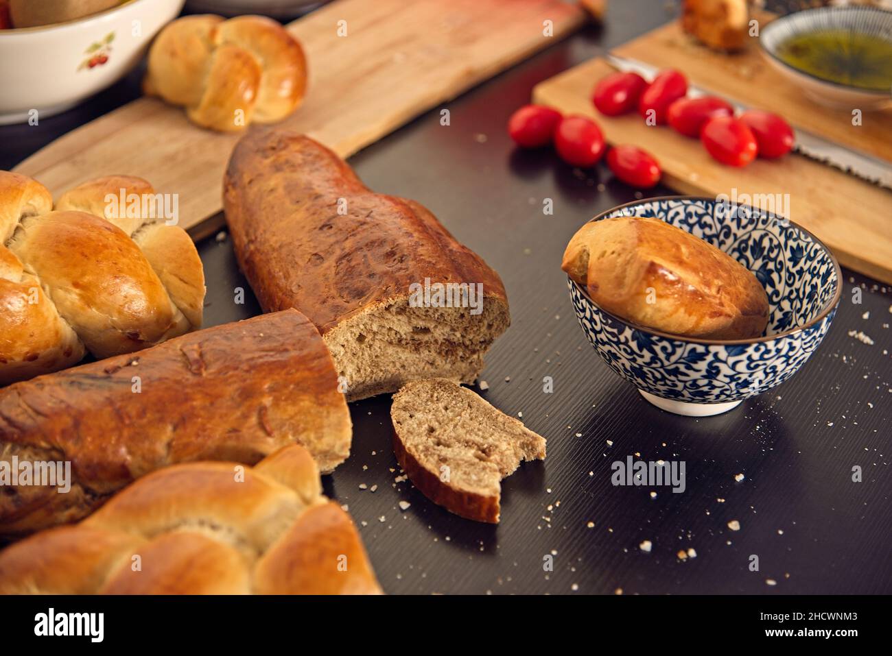 Feast, messy table. Bread in the shape of a braid. Sweet Challah ...