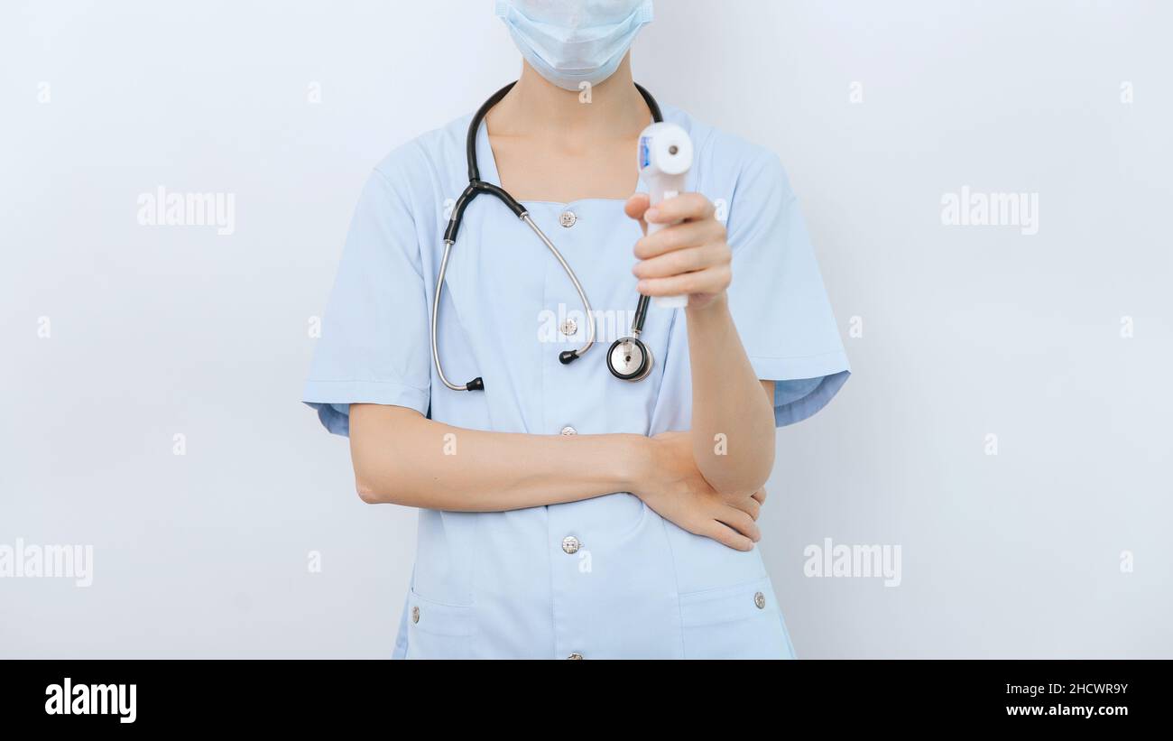 Temperature measurement gun in doctor hands. Close-up shot of doctor ...