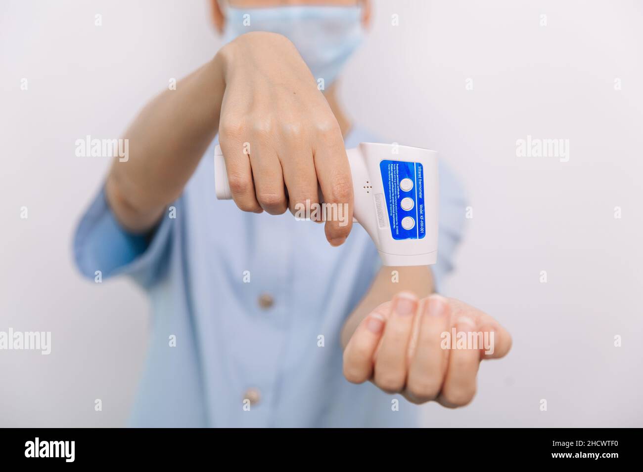 Temperature measurement gun in doctor hands. Close-up shot of doctor ...