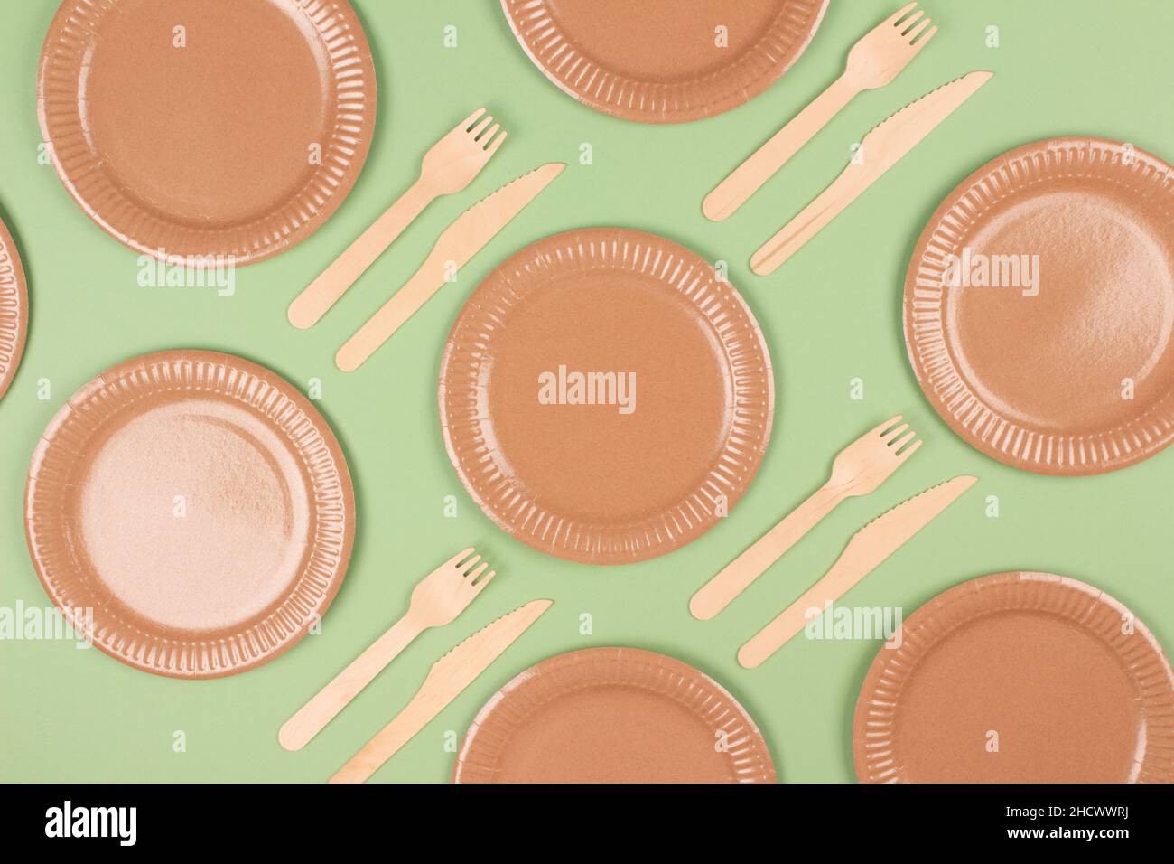 Flat lay composition with eco-friendly tableware on light green ...