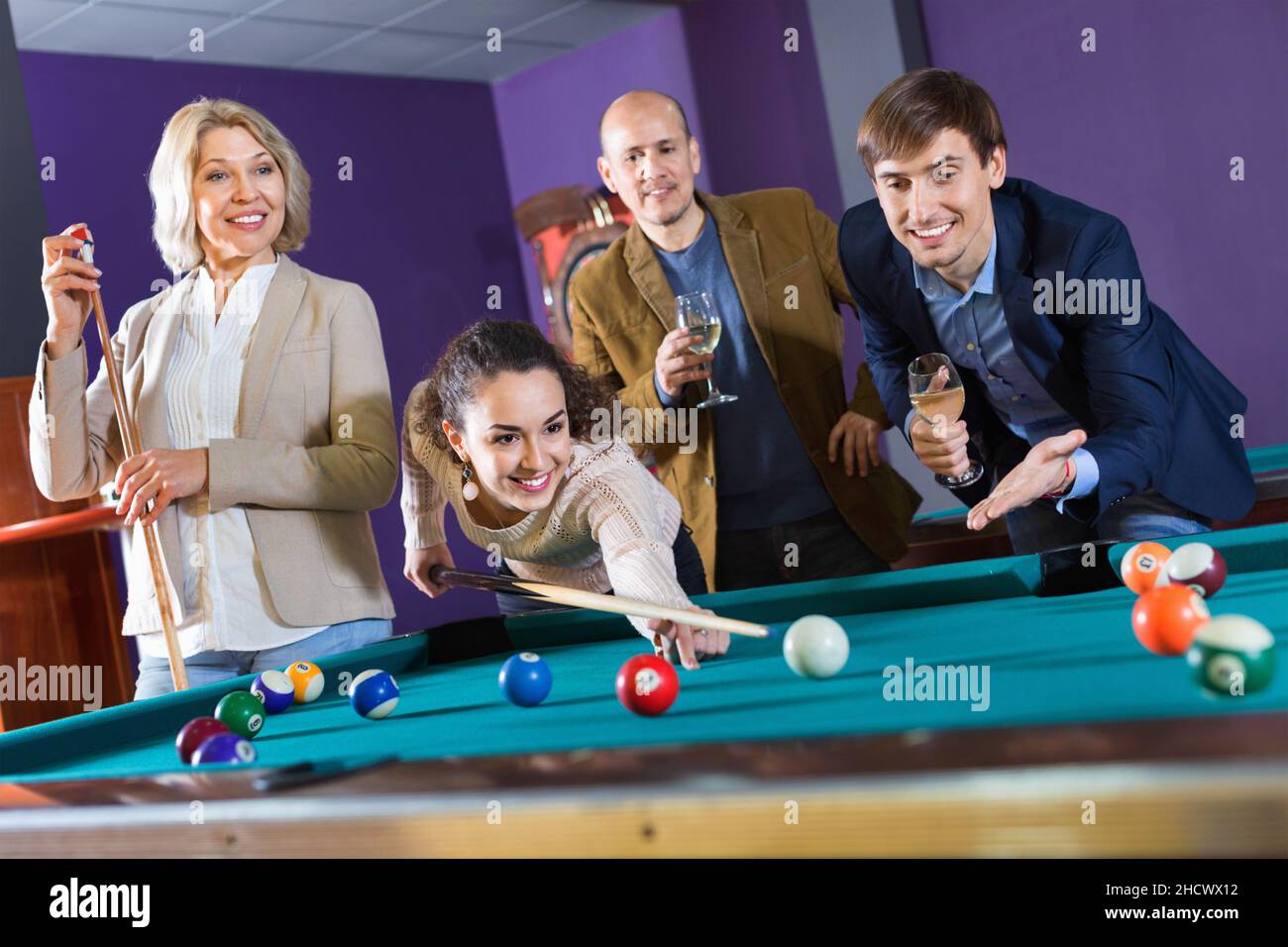 Happy female playing billiard hi-res stock photography and images - Alamy