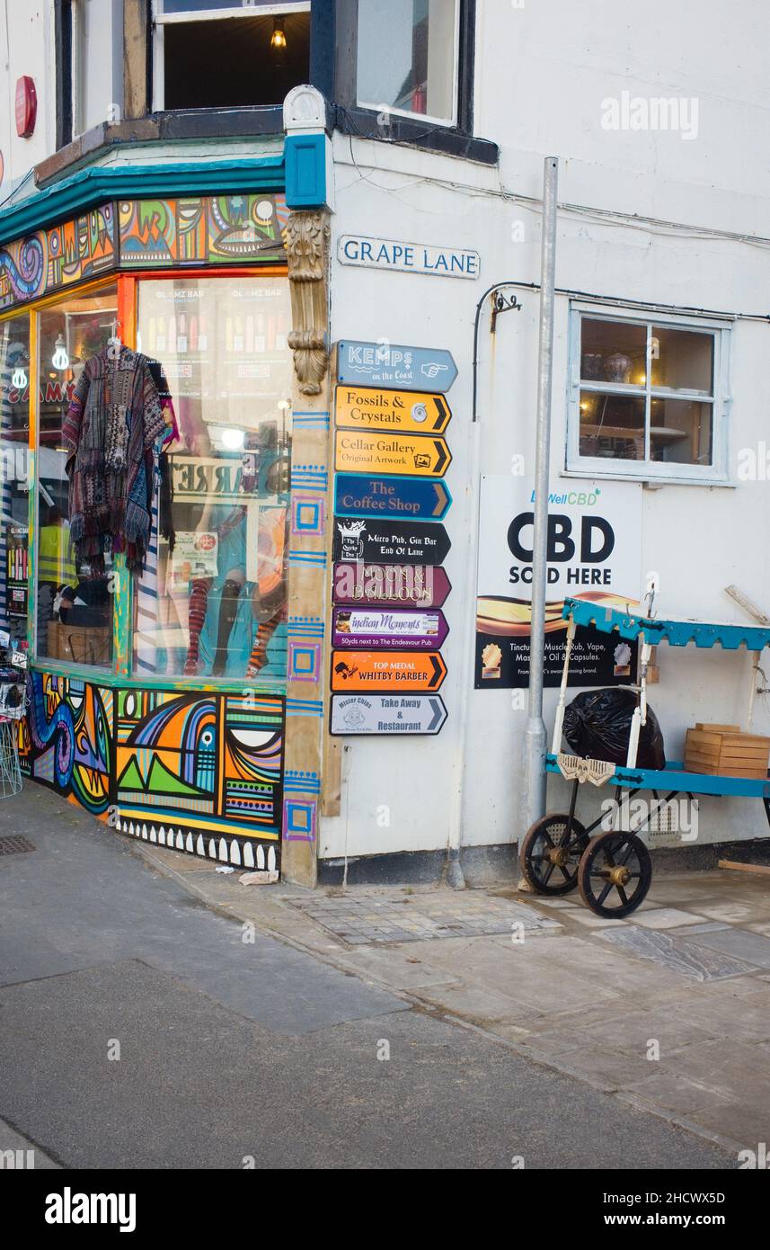 Grape Lane in Whitby with different shop signs displayed on wall Stock ...