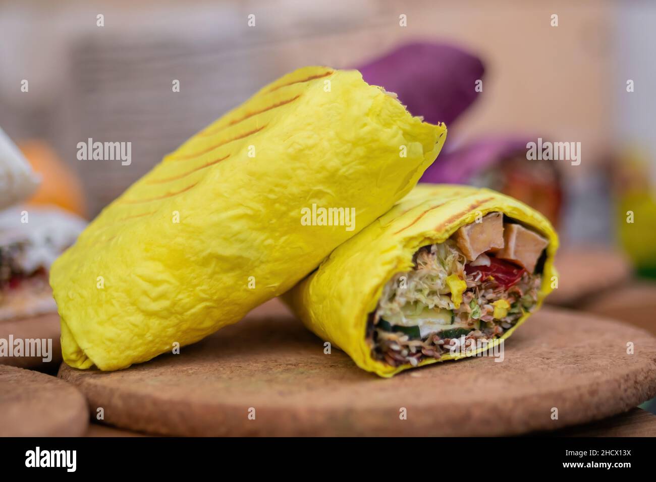 Fresh colorful vegan doner rolls with vegetables on counter at summer ...
