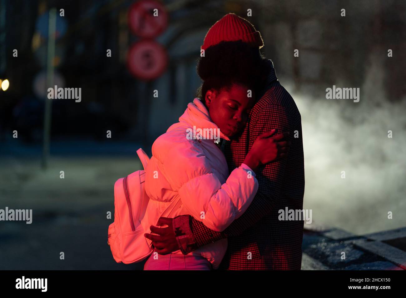 Affectionate sad young couple hug at dark street saying good bye to ...