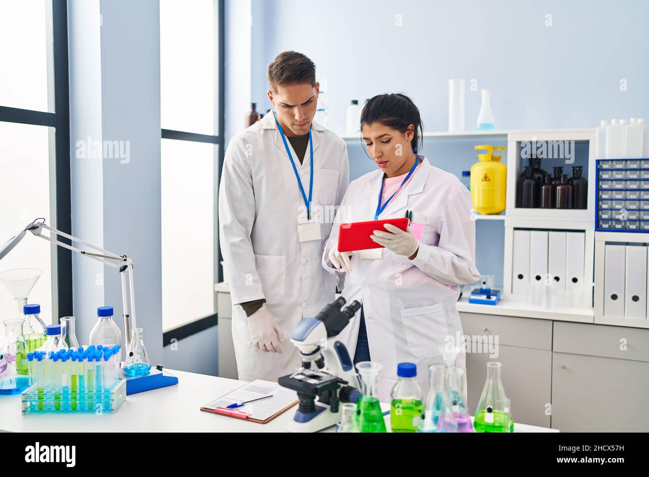 Man woman scientists using touchpad hi-res stock photography and images ...