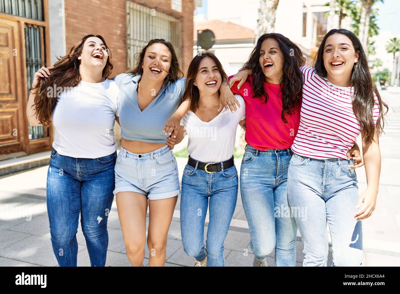 Group of young women friends smiling happy and hugging at the city ...
