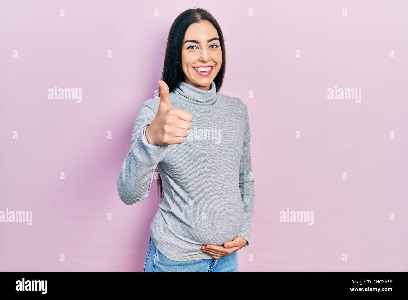 Beautiful woman with blue eyes expecting a baby, touching pregnant ...