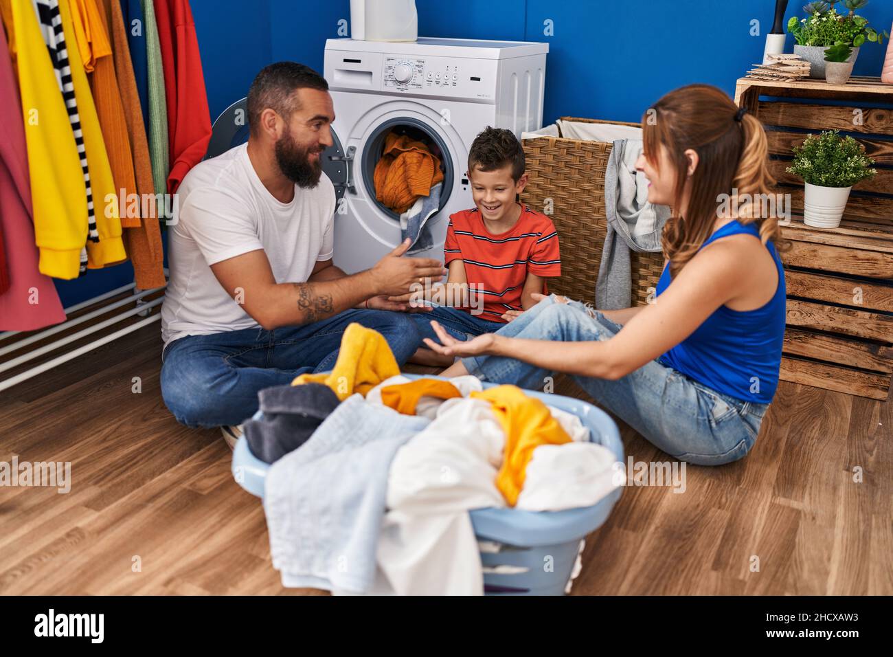 Family playing game washing clothes at laundry room Stock Photo - Alamy