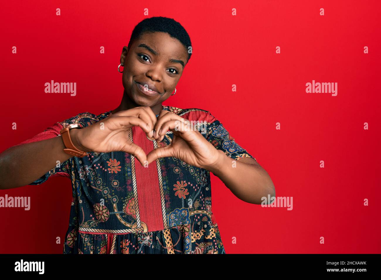Young african american woman wearing african style smiling in love ...