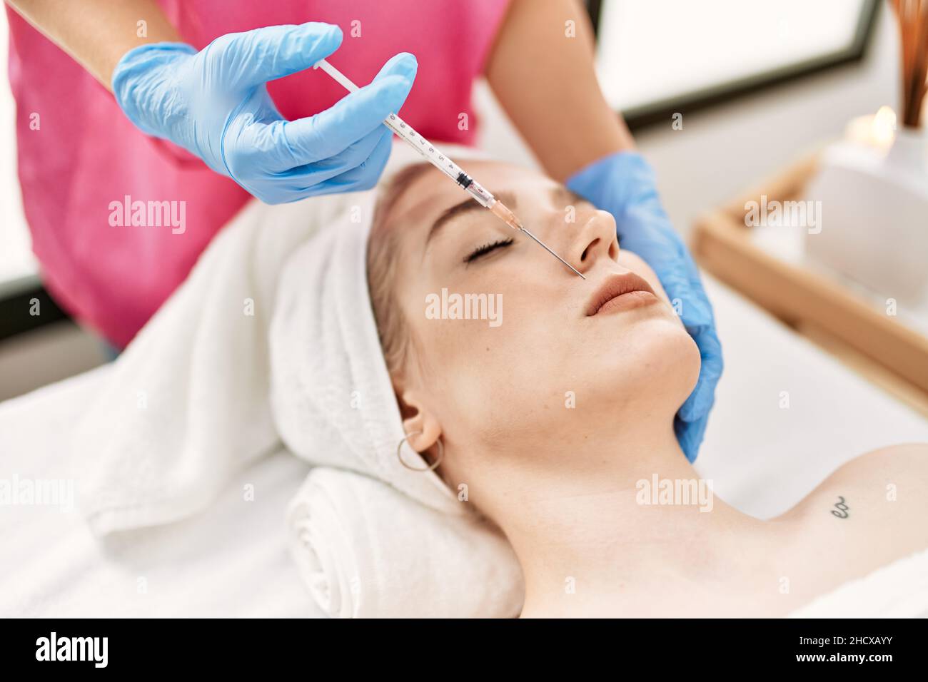 Doctor injecting botox on woman face for anti aging treatment at the ...