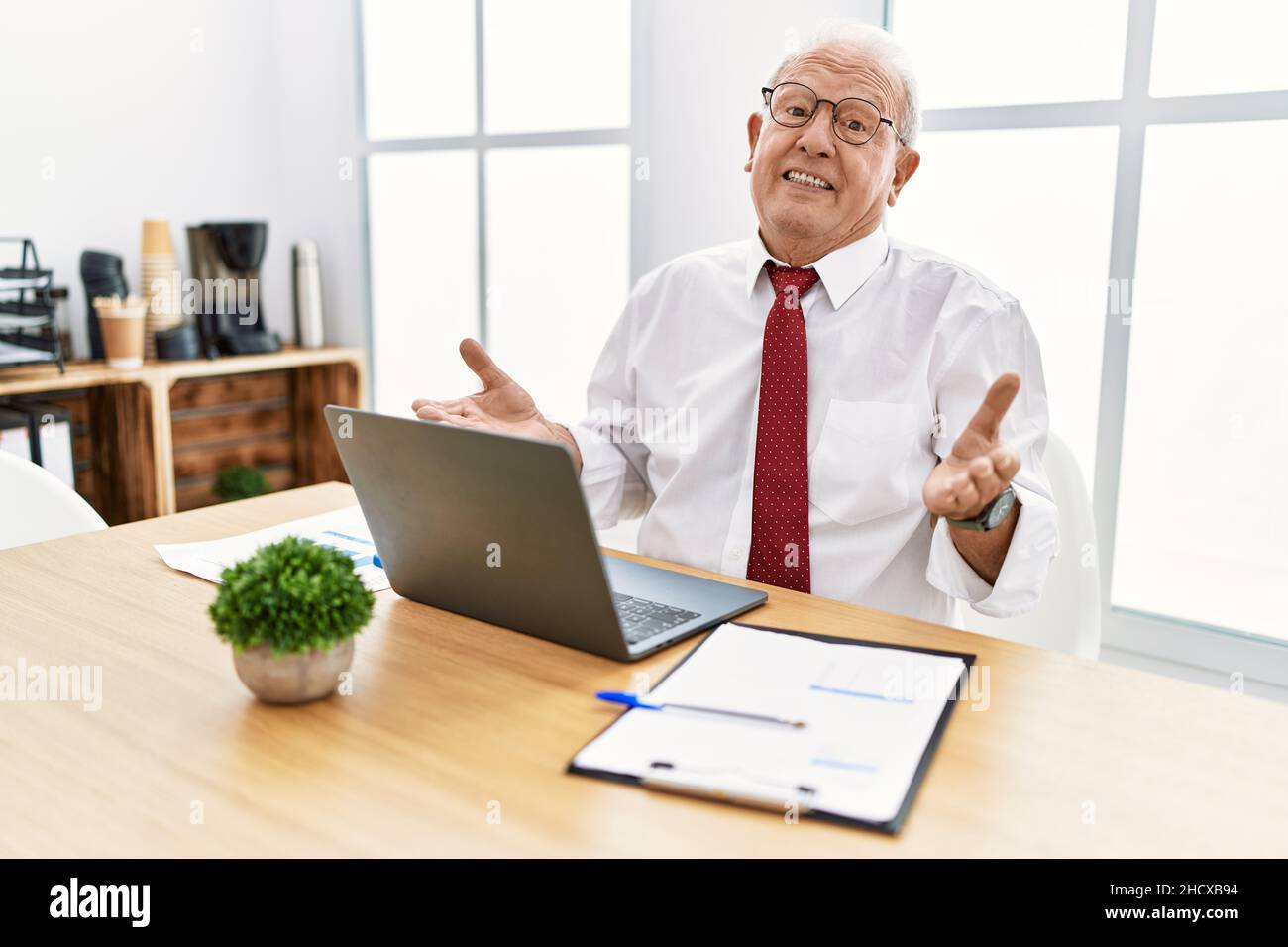 Senior man working at the office using computer laptop smiling cheerful ...