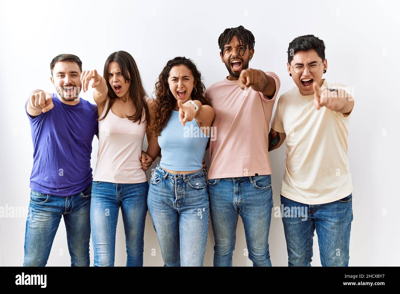 Group of young people standing together over isolated background ...
