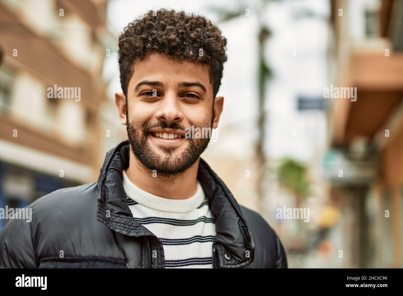 Young arab man smiling outdoor at the town Stock Photo - Alamy