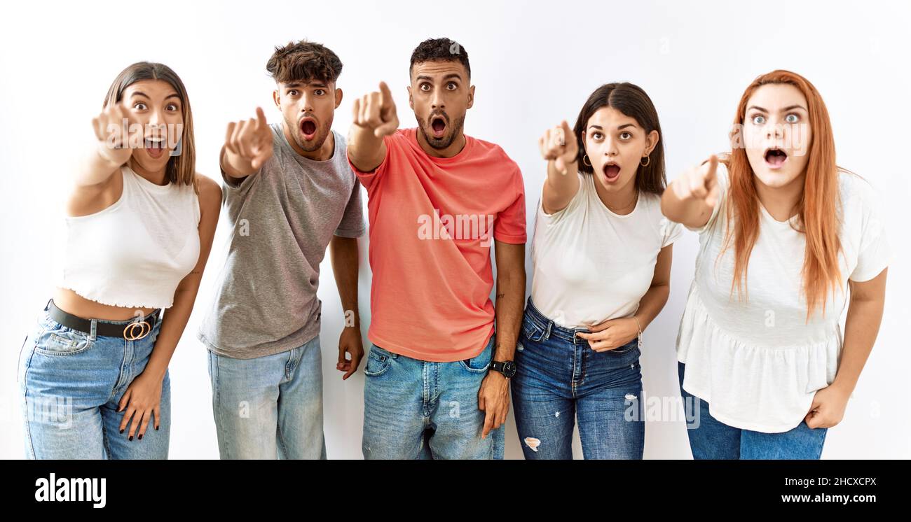 Group of young friends standing together over isolated background ...