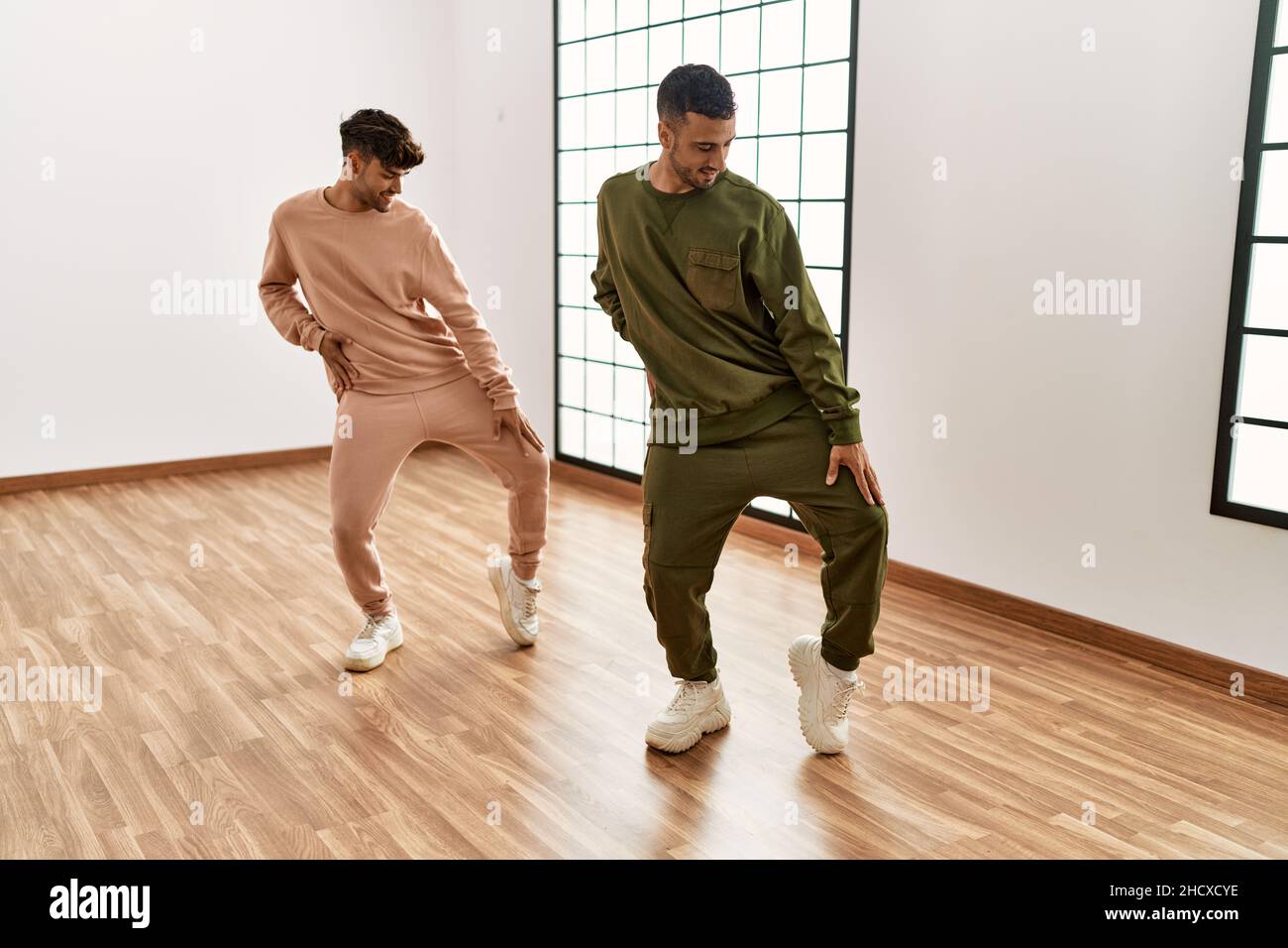 Two hispanic men couple dancers smiling confident dancing at sport ...
