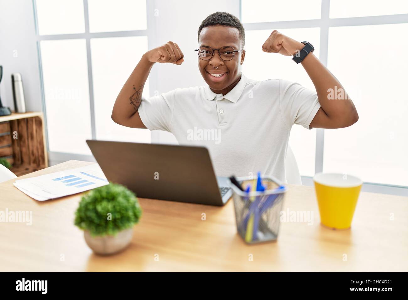 Young african man working at the office using computer laptop showing ...