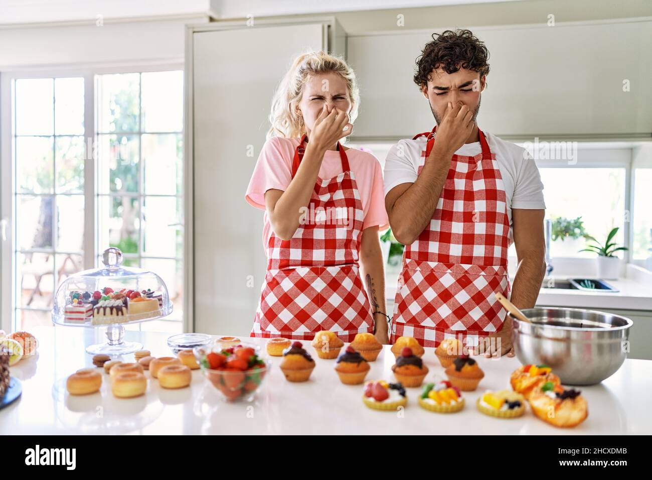 Couple of wife and husband cooking pastries at the kitchen smelling ...