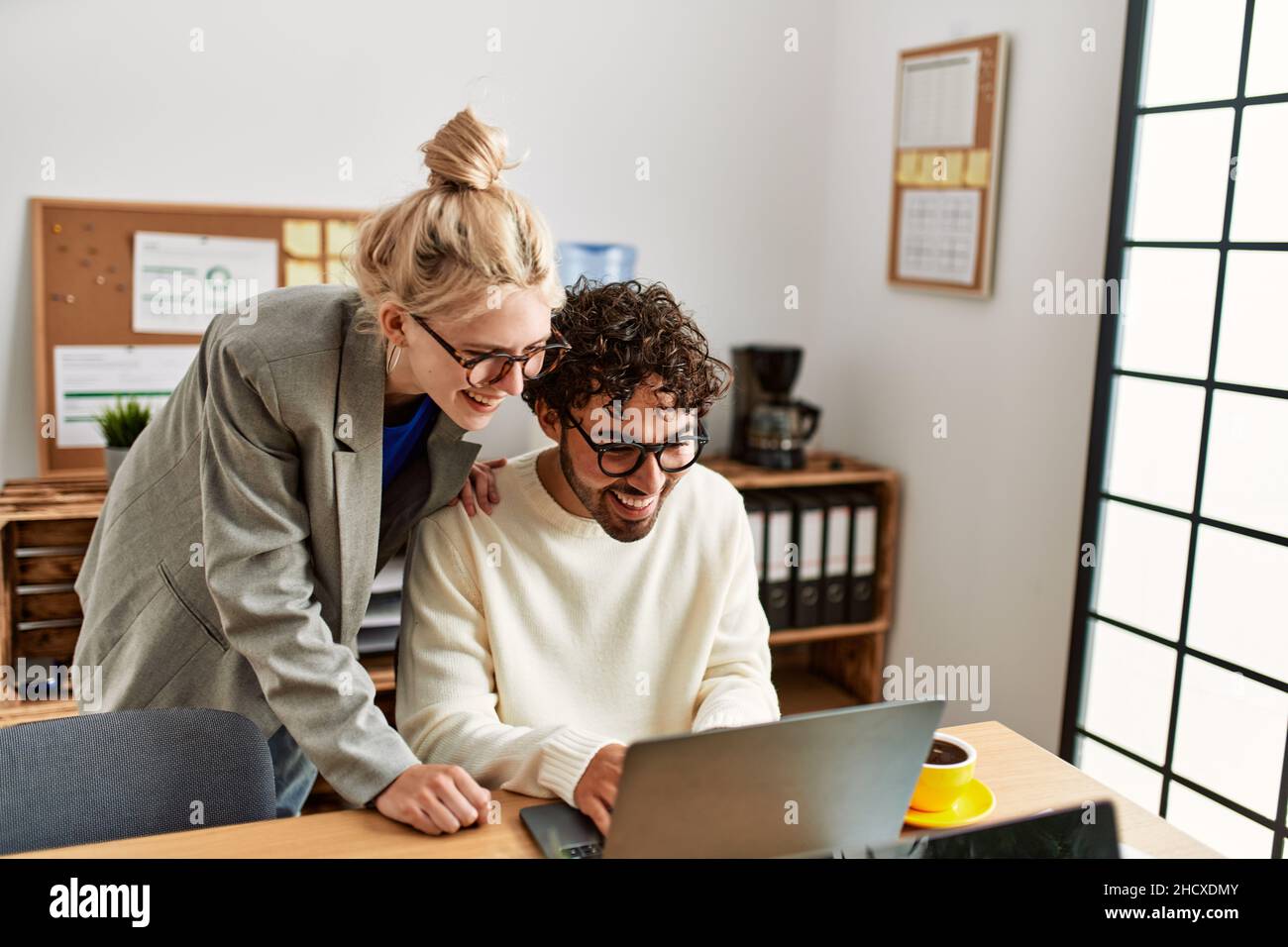 Two hispanic business workers smiling happy working at the office Stock ...