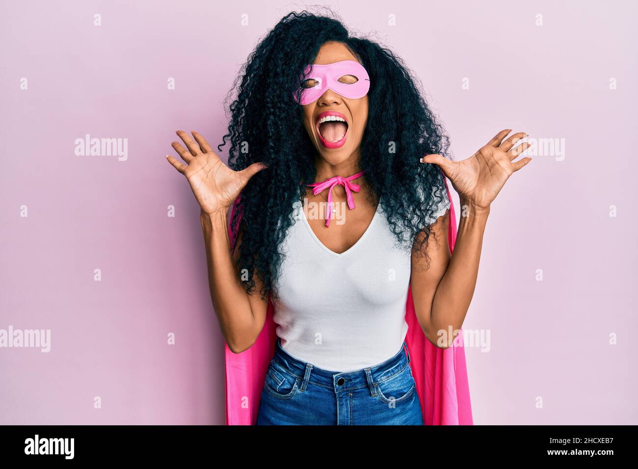 Middle age african american woman wearing super hero costume ...