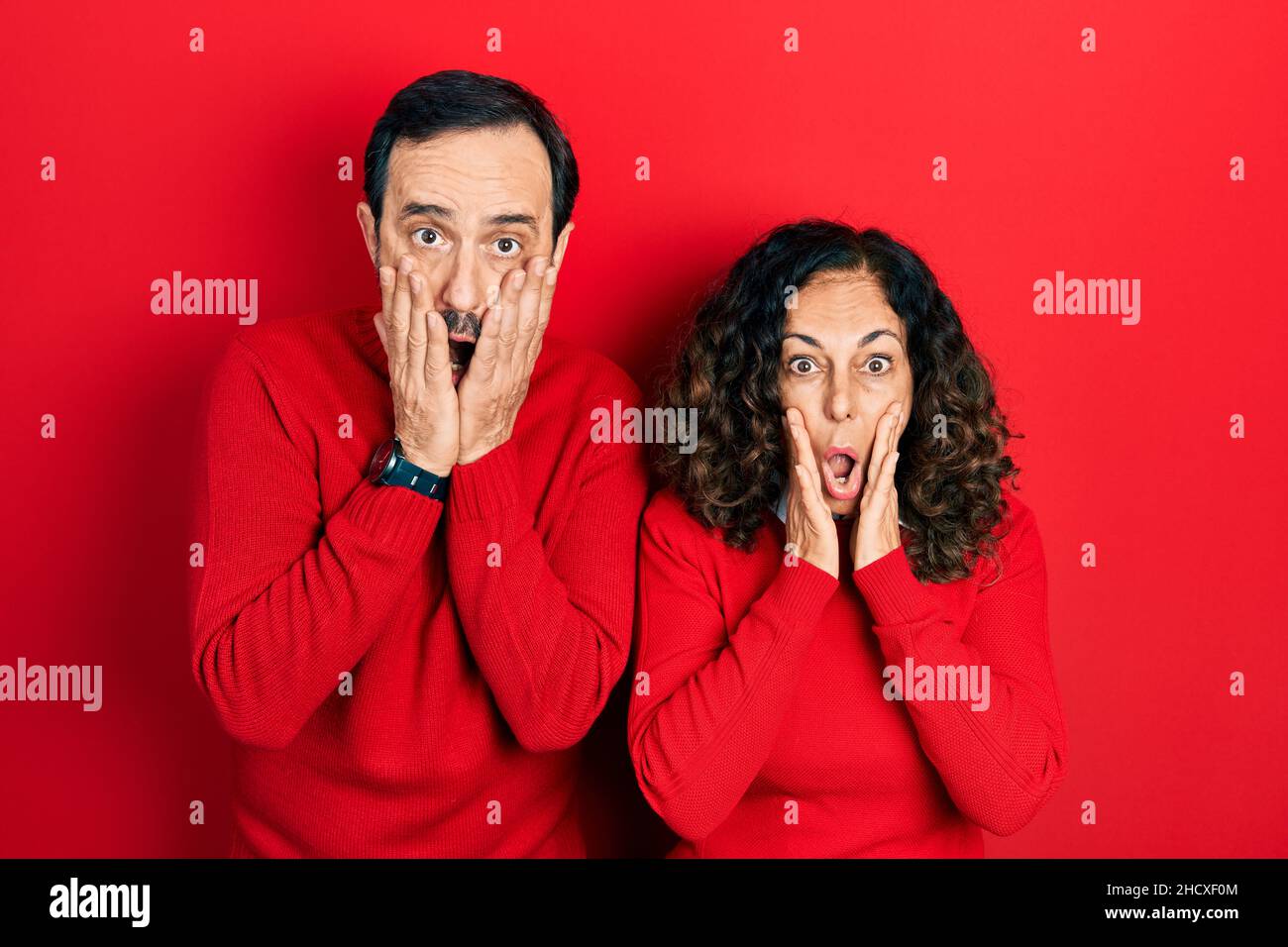 Middle age couple of hispanic woman and man hugging and standing ...