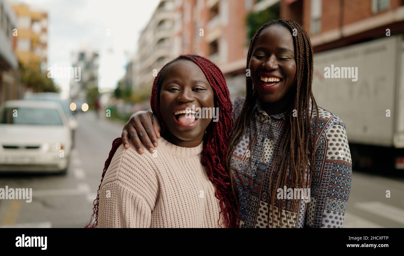 Two african american friends smiling confident hugging each other ...