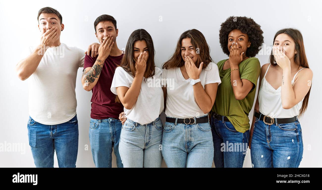 Group of young friends standing together over isolated background ...