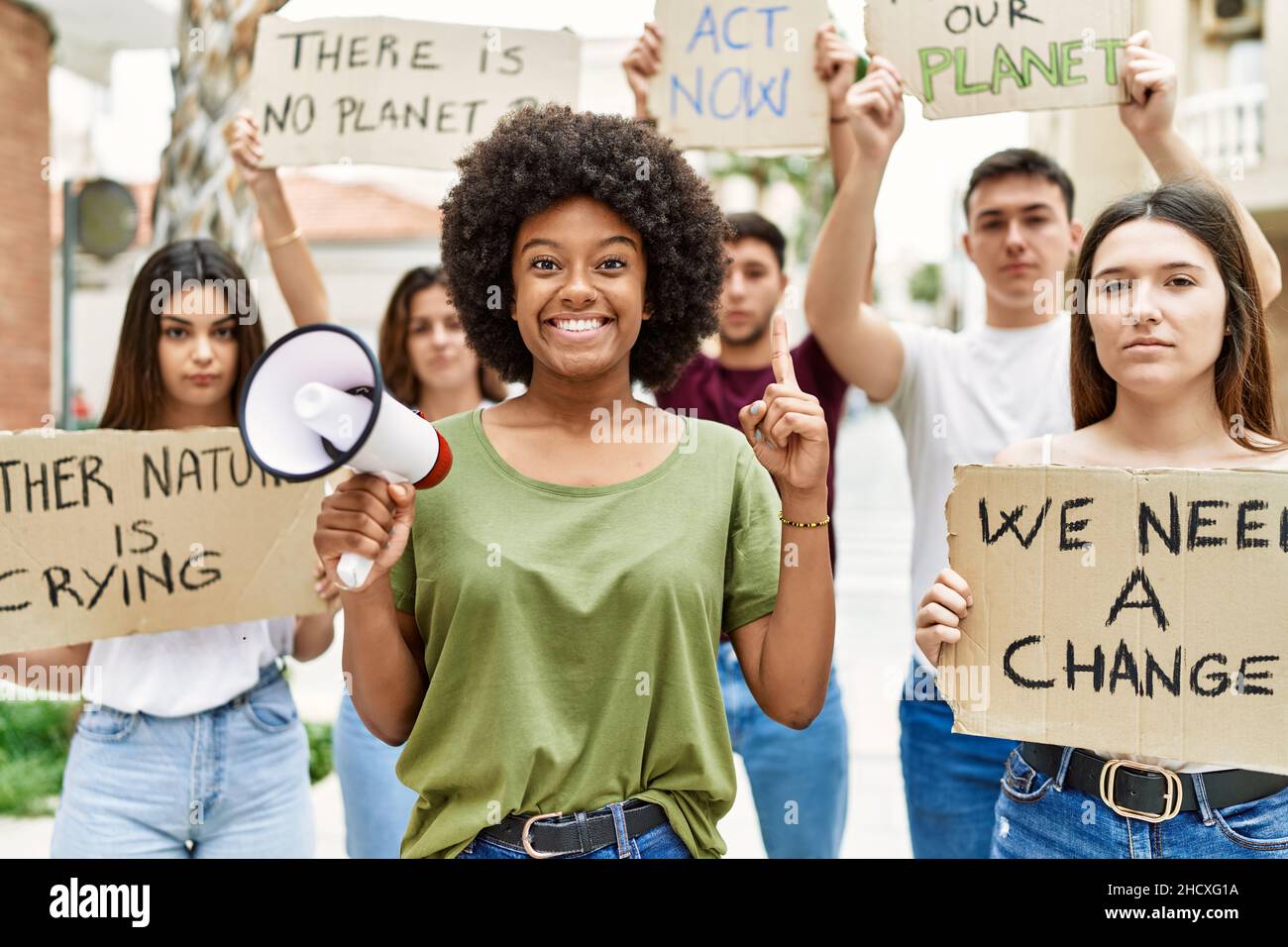 Group of young friends protesting and giving slogans at the street ...