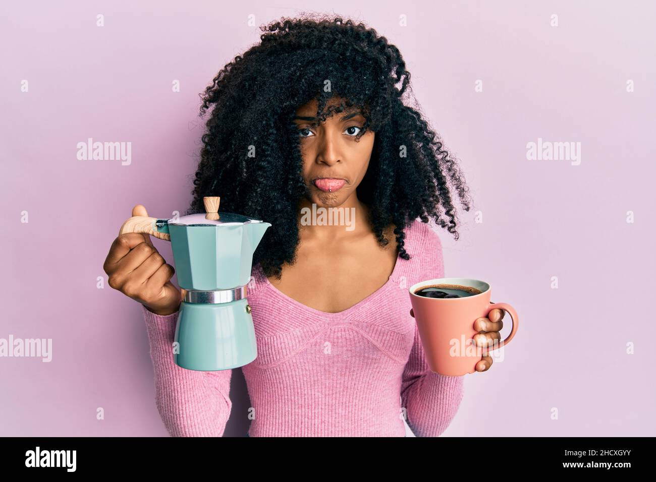 African american woman with afro hair drinking italian coffee depressed ...