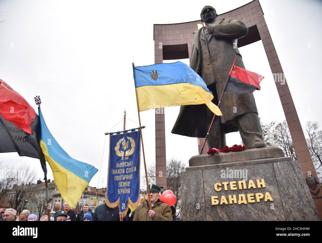 People hold flags near the monument to Stepan Bandera during the ...