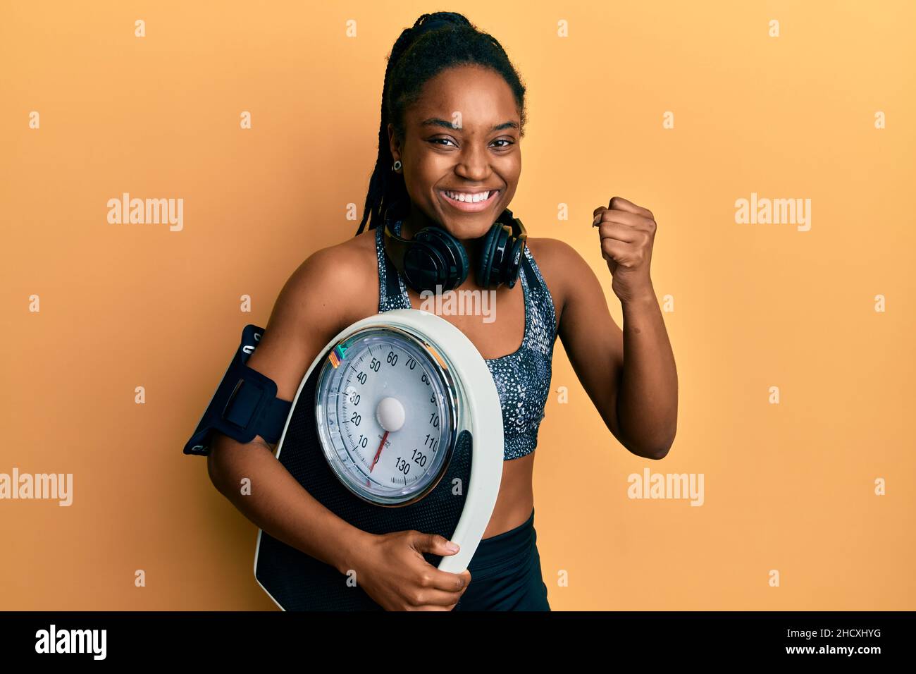 African american woman with braided hair wearing sportswear holding ...