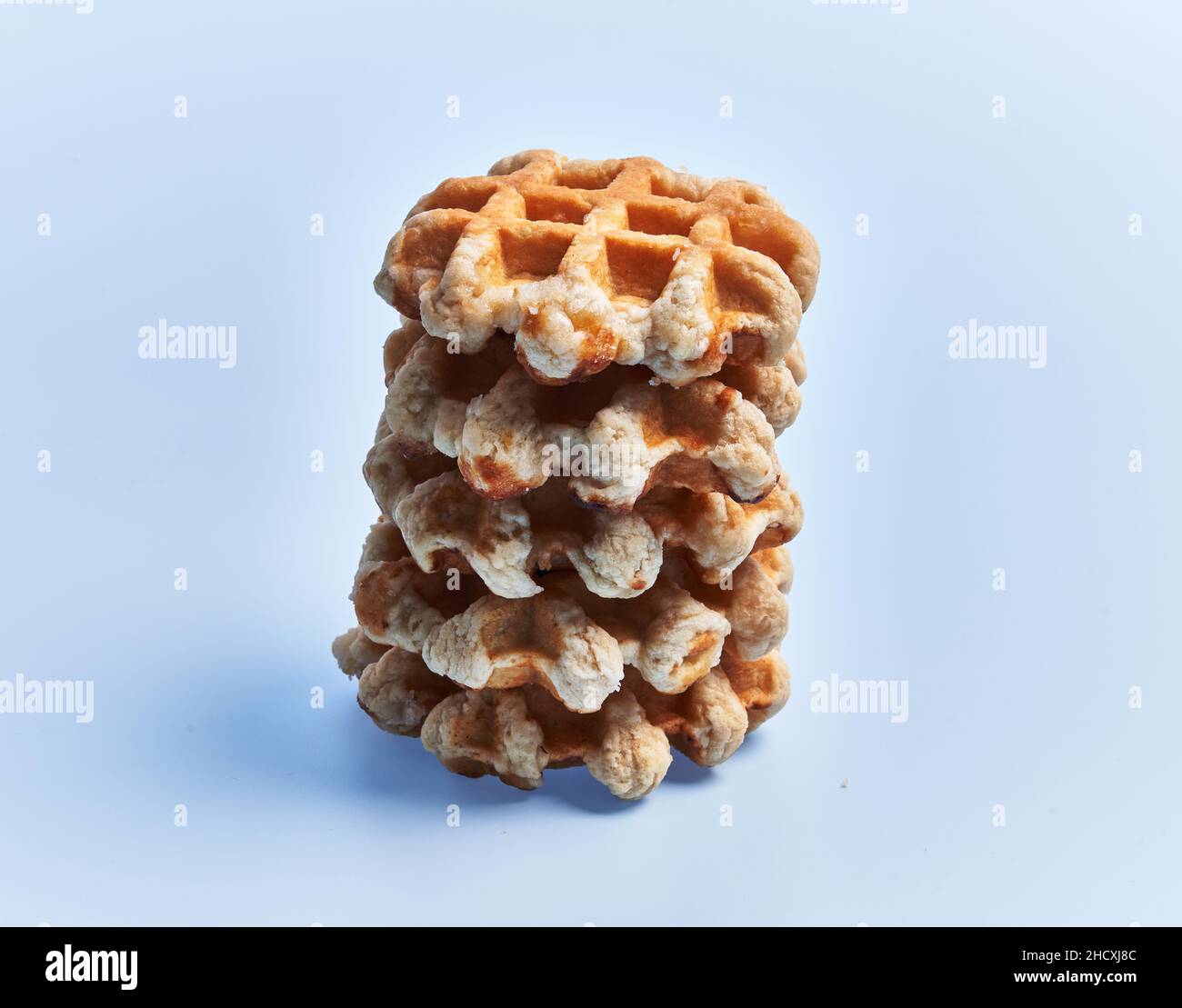 Bunch of delicious waffles over blue background Stock Photo - Alamy