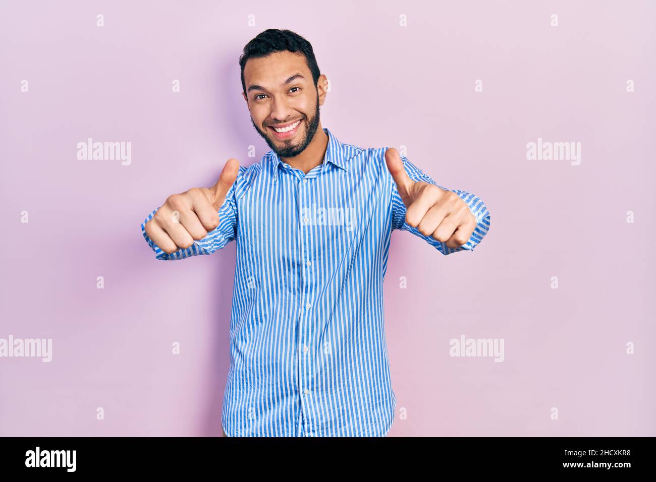 Hispanic man with beard wearing casual blue shirt approving doing ...