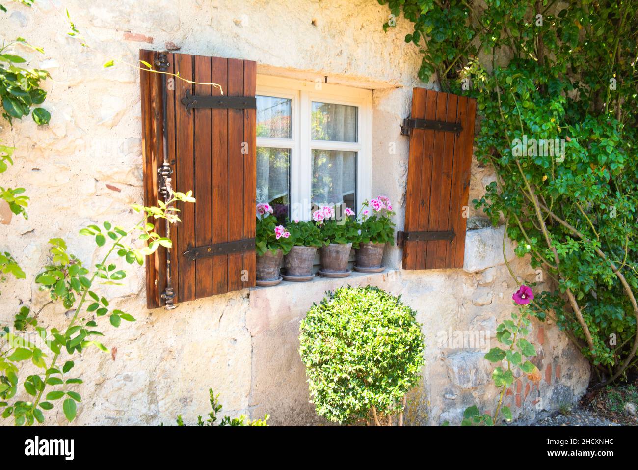 Romantic French window with geraniums Stock Photo - Alamy