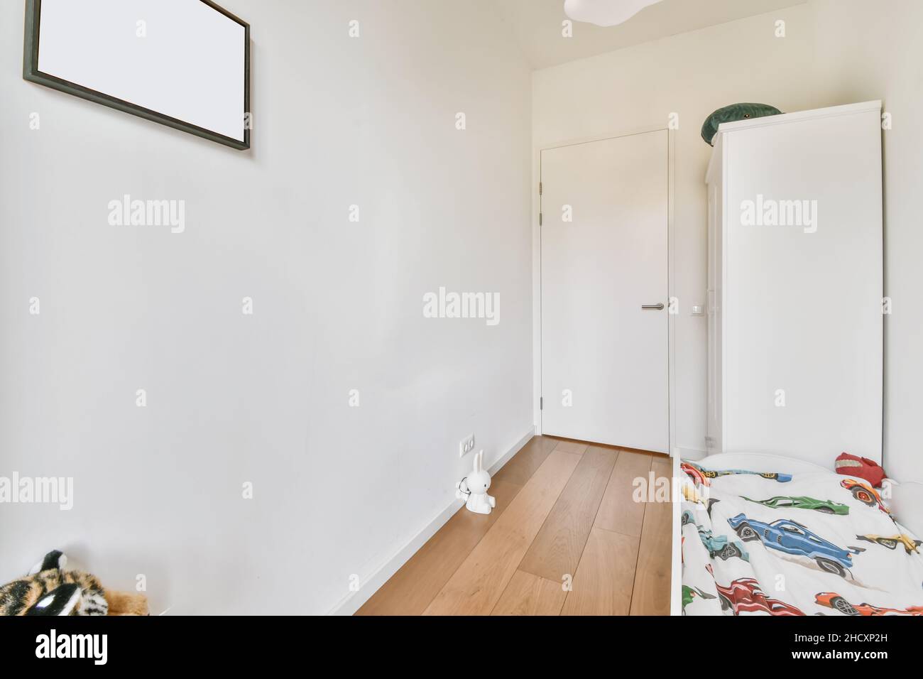 Superb kids room with wood parquet flooring and white walls Stock Photo ...