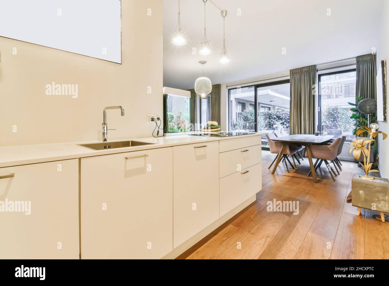 Superb kitchen with white kitchen unit and painting on the wall Stock ...