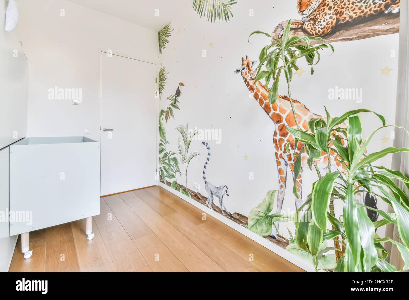 Superb kids room with wood parquet flooring and white walls Stock Photo ...