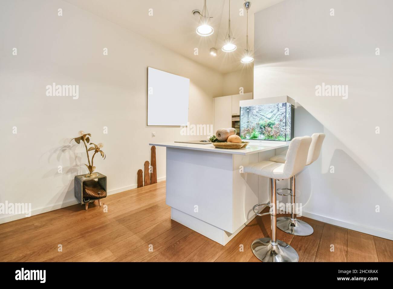 Superb kitchen with white kitchen unit and painting on the wall Stock ...