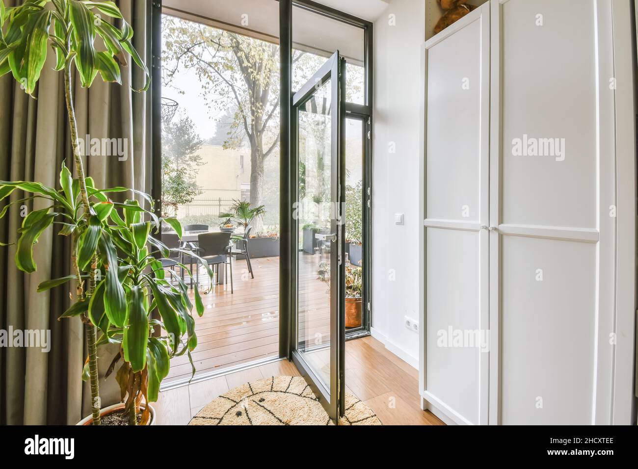Superb room with open glass door overlooking the courtyard Stock Photo ...