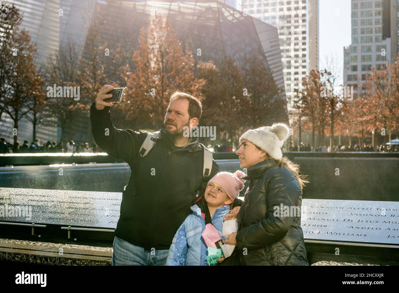 New York, USA. 26th Dec, 2021. A family poses for pics at the 9/11 ...