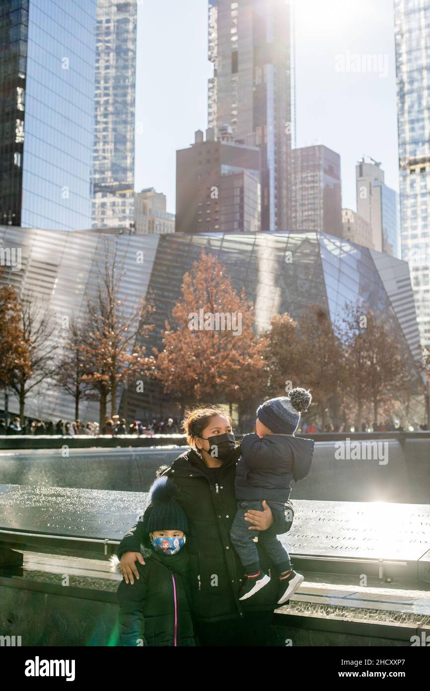 New York, USA. 26th Dec, 2021. A woman with her kids poses for pics at ...