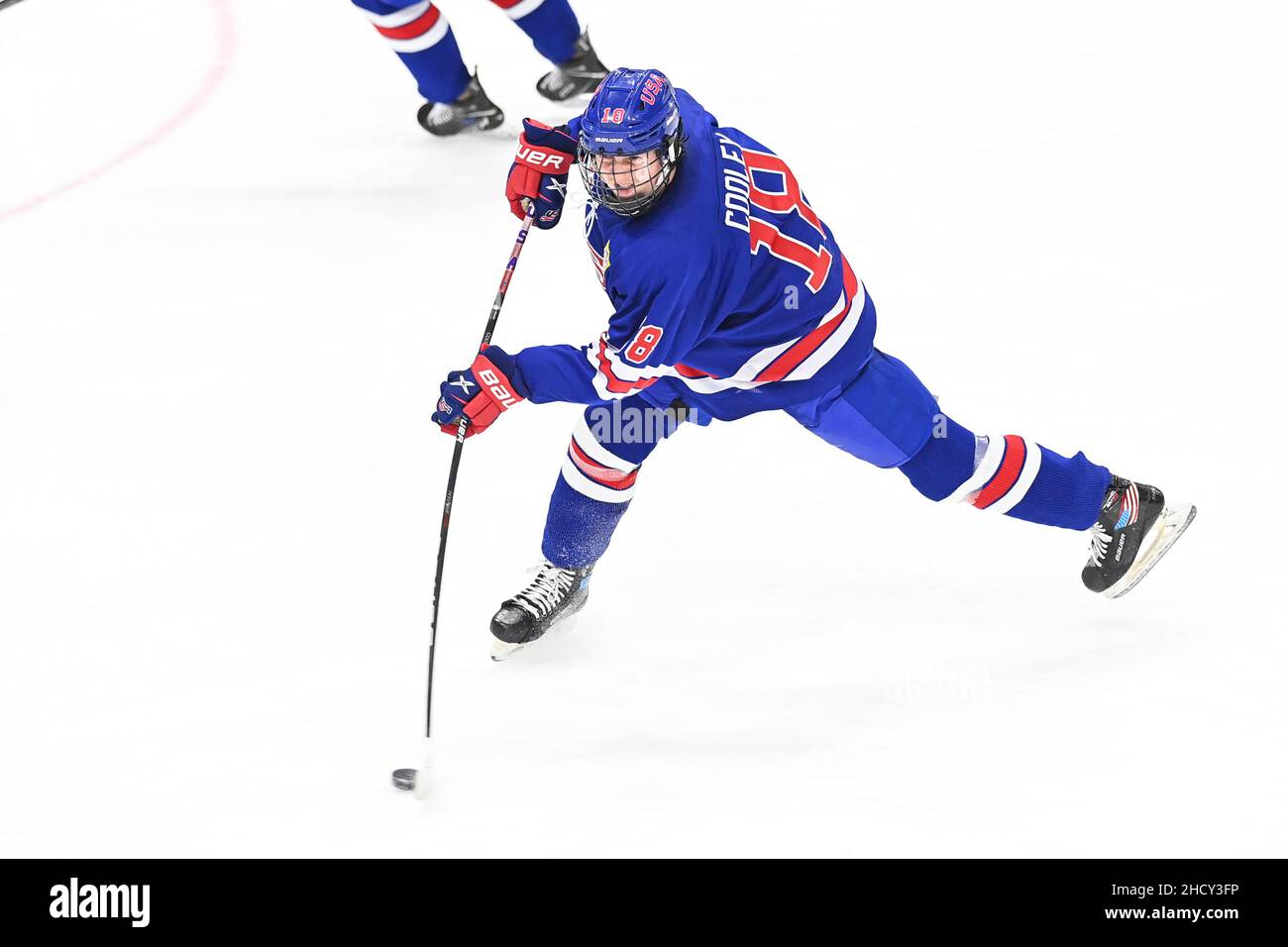 U.S. National Under-18 team forward Logan Cooley (18) passes the puck ...