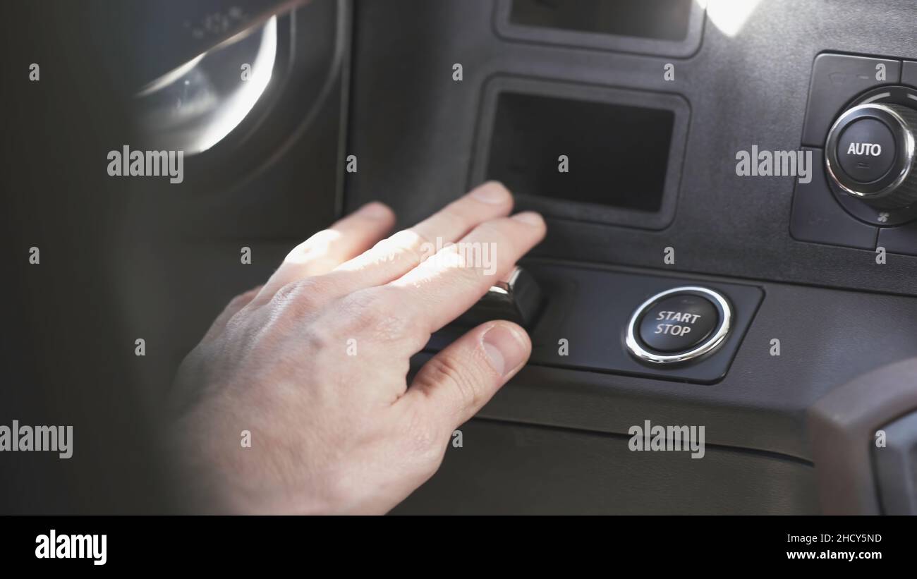Close up of man hand pushing the car starting or stopping button to ...