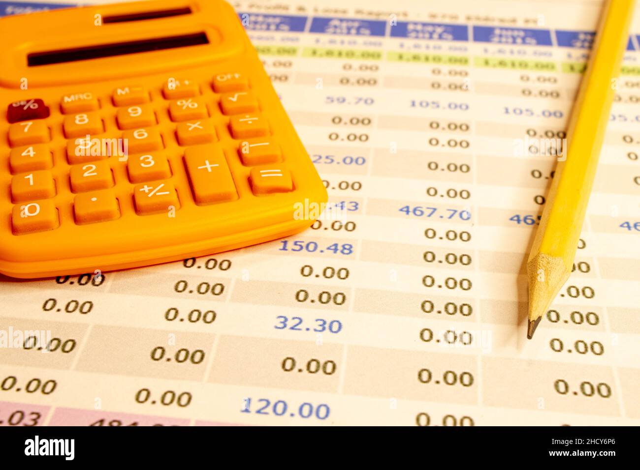 Orange calculator on a bright blue paper background. Office supplies ...