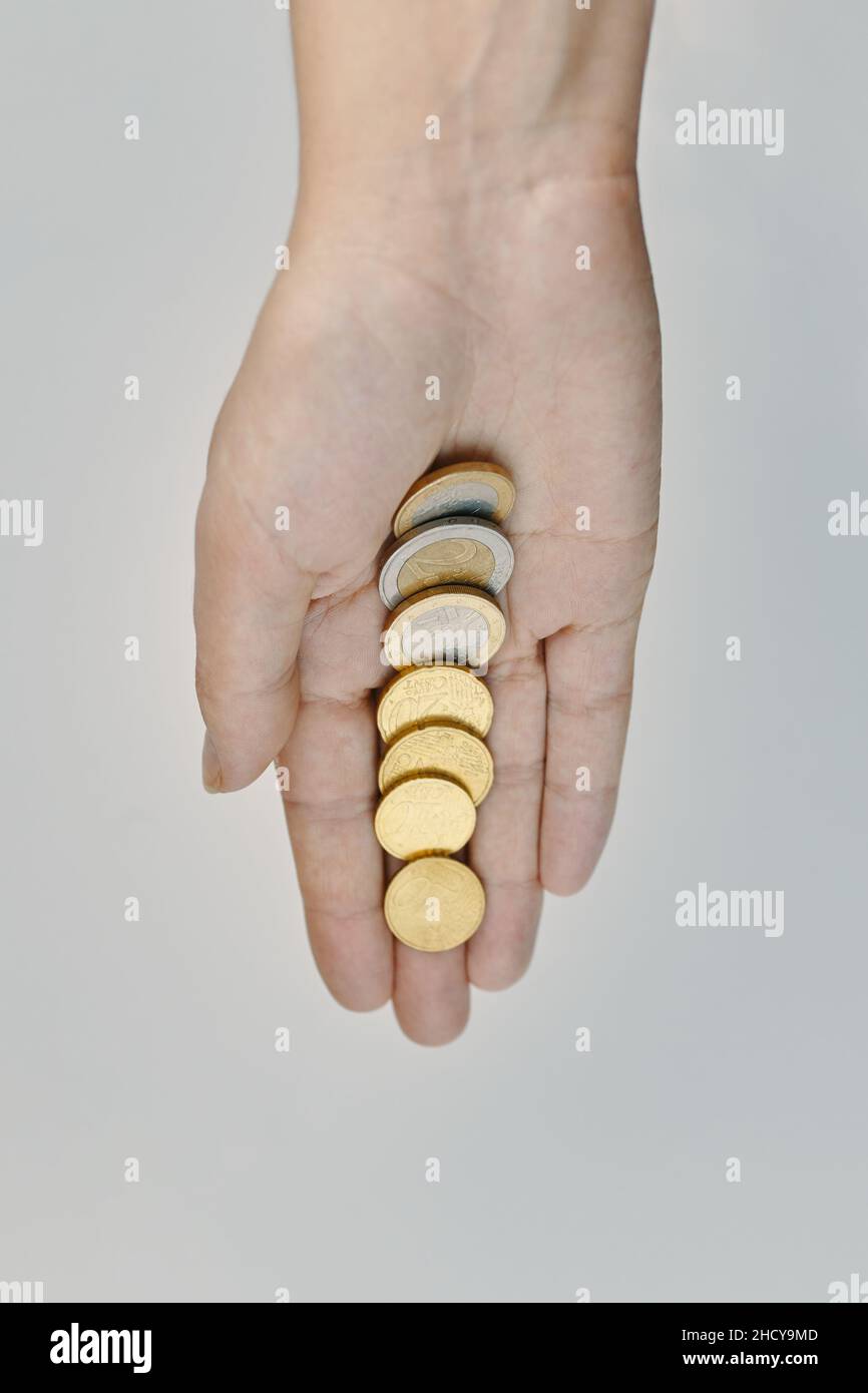 Coins in person's hands Stock Photo - Alamy